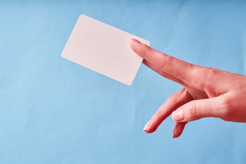 A Woman`s Hand Holds a White Plastic Card. Isolated Card in Hand Stock ...