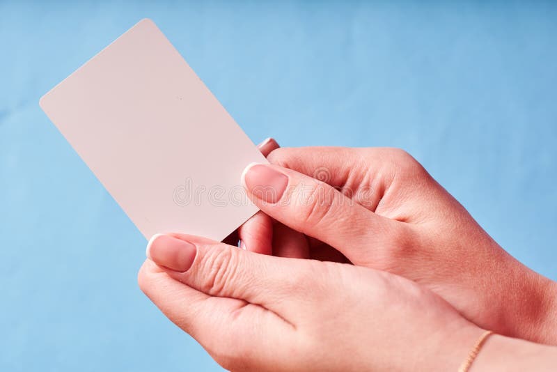 A Woman`s Hand Holds a White Plastic Card. Isolated Card in Hand Stock ...