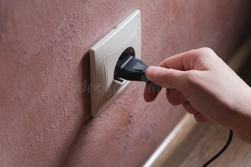 A Woman& X27;s Hand Inserts an Electric Plug into a Socket, Close-up ...