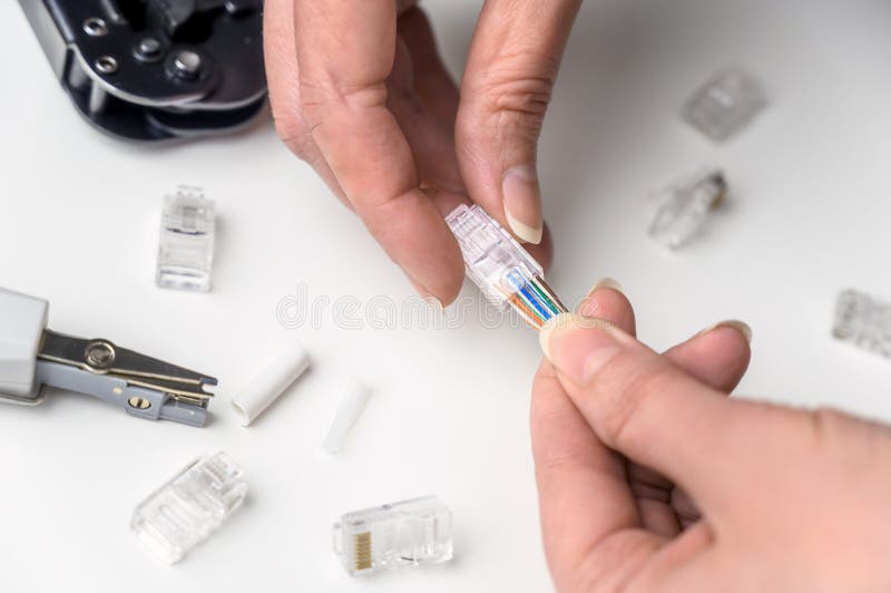 A Woman S Hand Inserts an Internet Cable into a Clamp Connector. Utp ...