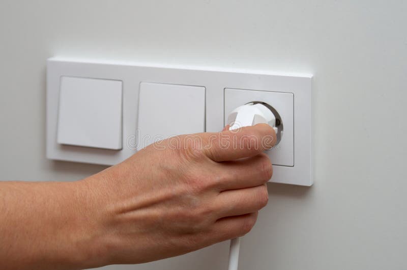 Woman S Hand Plugs an Electric Plug into a Socket Stock Image - Image ...