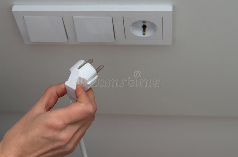 Woman S Hand Plugs an Electric Plug into a Socket Stock Photo - Image ...