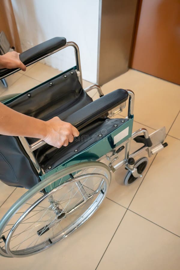 Woman`s Hand Pulling Wheelchair from the Wheelchair Parking Stock Image ...