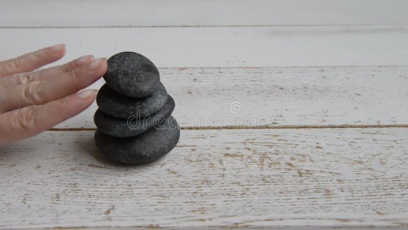 A Woman S Hand Pushed a Stack of Stones on the Table Stock Footage ...