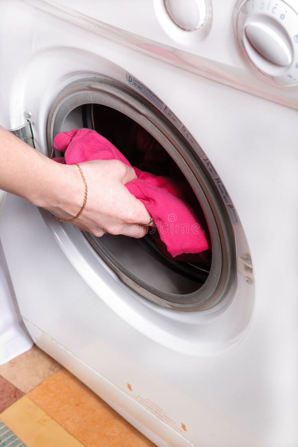 Woman S Hand Puts the Laundry Stock Photo - Image of cleaning, clothes ...