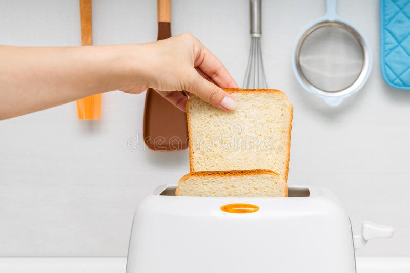 Woman& X27;s Hand Putting Bread into the Toaster Stock Photo - Image of ...