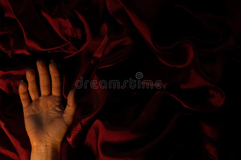 A Woman S Hand on a Red Silk Crumpled Background in the Dark, Hand ...