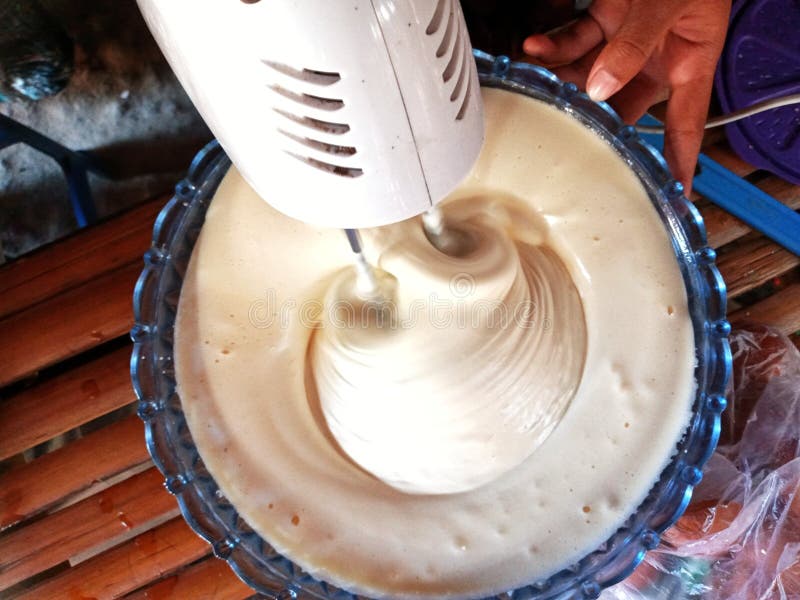 A Woman& X27;s Hand Using Mixer Kitchen Tool To Mix Egg Mixture for ...