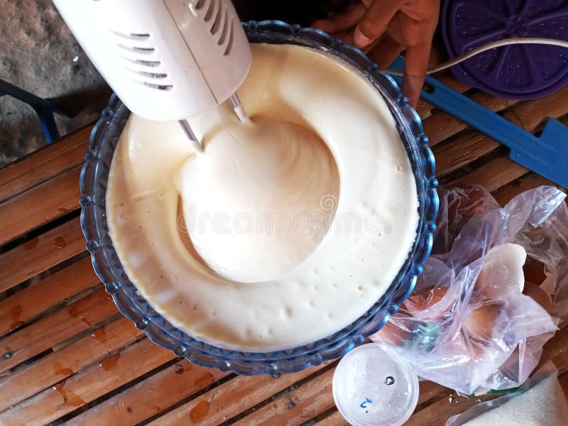 A Woman& X27;s Hand Using Mixer Kitchen Tool To Mix Egg Mixture for ...