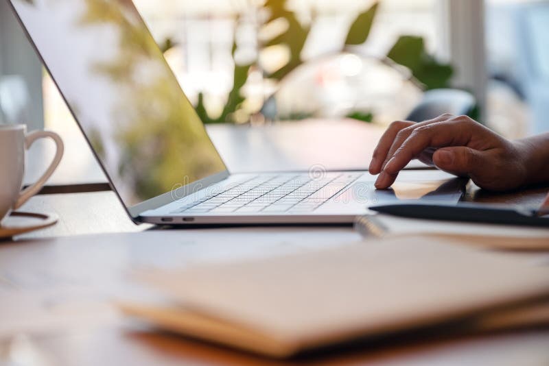 A Woman`s Hand Using and Touching on Laptop Touchpad with Notebooks and ...
