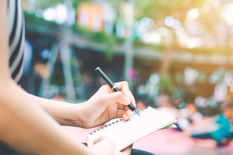 The Woman`s Hand is Writing on a Blank Notepad Stock Photo - Image of ...