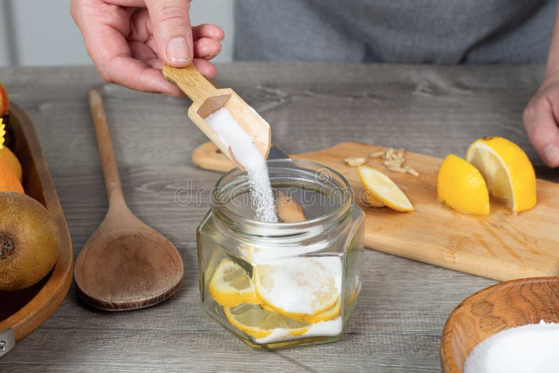 Woman`s Hands Canning Lemon. Pour Sugar into Jar of Lemon Stock Photo ...