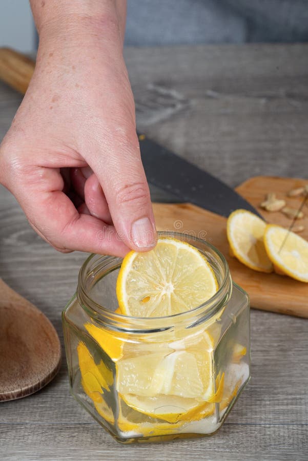Woman`s Hands Canning Lemon. Pour Sugar into Jar of Lemon Stock Photo ...