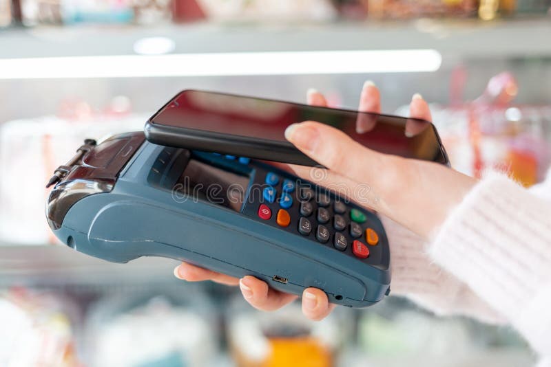 A Woman`s Hands is Holding a Payment Terminal and Paying for a Purchase ...