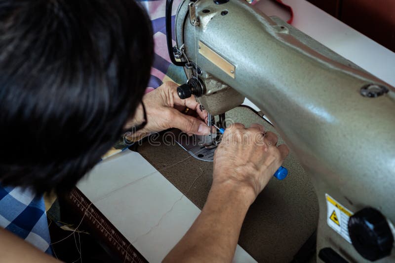 Woman`s Hands Sewing Fabric Repairs on Old Sewing Stock Image - Image ...