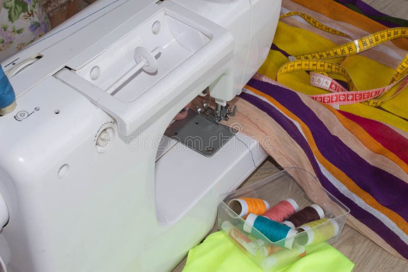 Woman`s Hands Using Sewing Machine with Reels of Colour Threads Stock ...