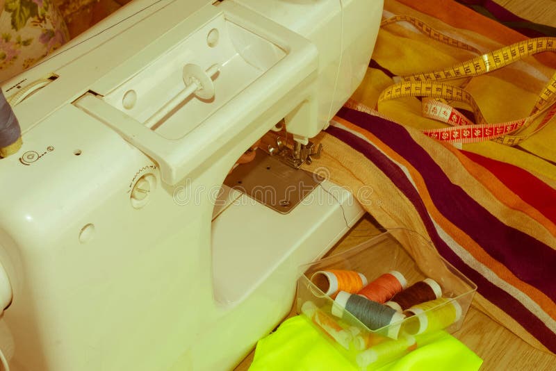 Woman`s Hands Using Sewing Machine with Reels of Colour Threads Stock ...