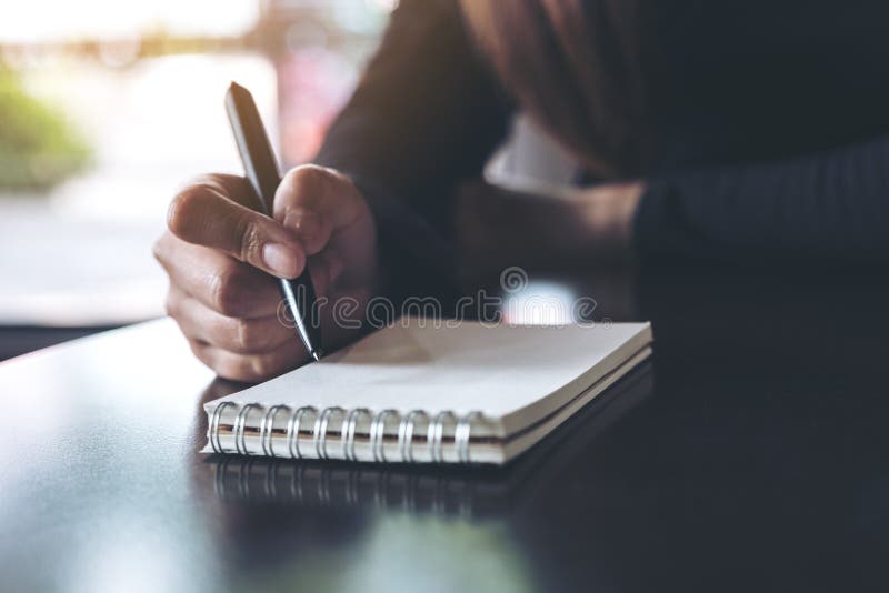 A Woman`s Hands Writing Down on a White Blank Notebook on Table Stock ...