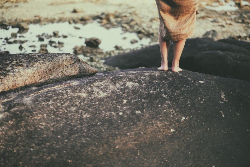 A Woman`s Legs while Standing on the Rock by the Beach Stock Image ...