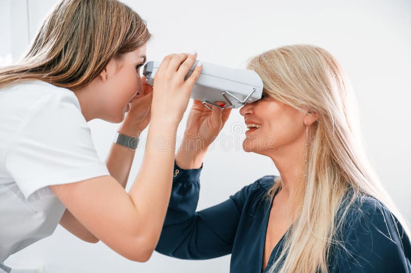 Woman`s Vision is Tested by Clinic Worker that Using Special Device ...