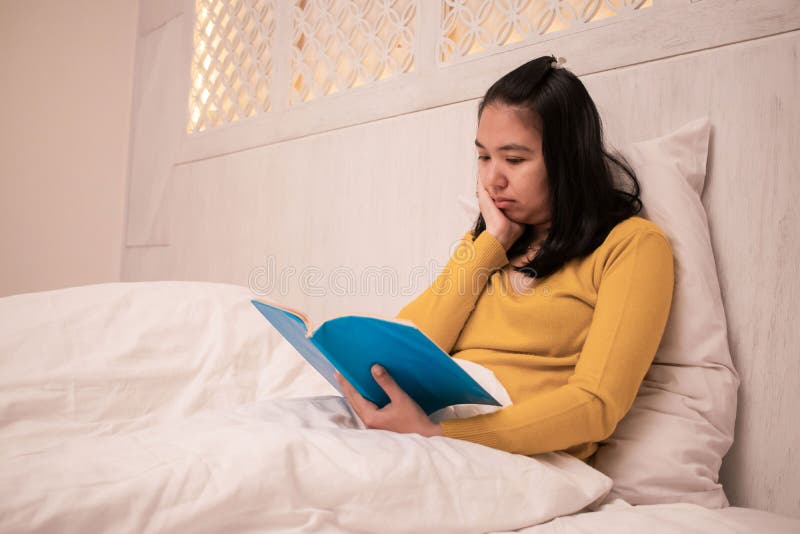 A Woman Sad while Reading a Book Stock Image - Image of leggings ...