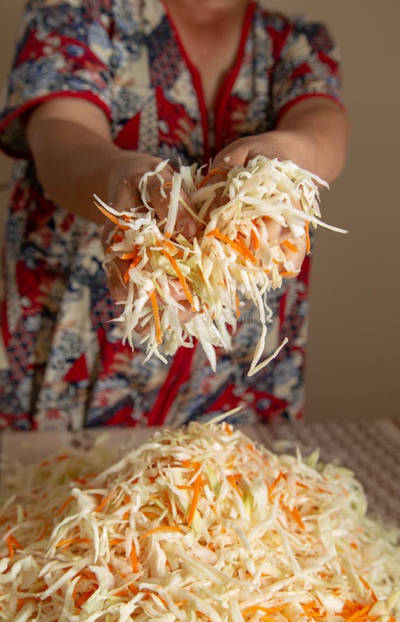 Woman Salting Cabbage with Carrots in the Kitchen Stock Image - Image ...