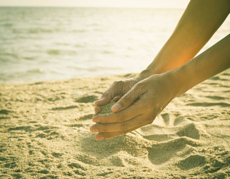 Woman with sand in hands stock photo. Image of finger - 74146312