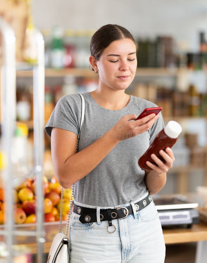 Woman Scanning a Package of Ketchup Stock Photo - Image of mobile, sell ...