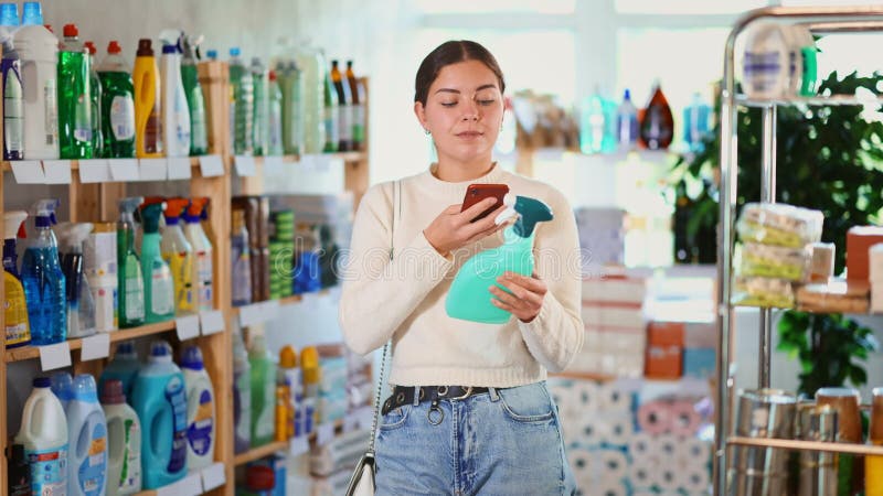 Female Customer Scans the Barcode of a Package of Household Cleaner ...