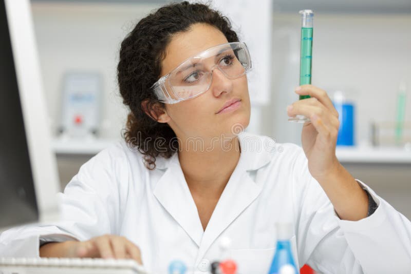Woman Scientist Checking Liquid Test Tube Stock Photo - Image of fluid ...