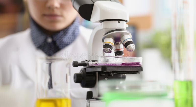 Woman Scientist Explore Purple Sample Under Microscope in Laboratory ...