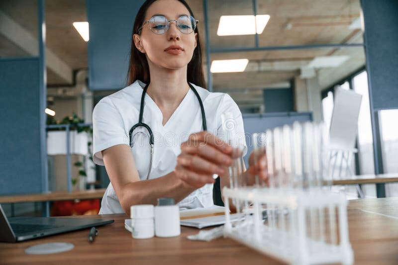 Woman Scientist with Stethoscope is Sitting in Lab and Working with ...