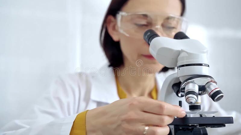 Woman Scientist Using Microscope in Laboratory. Microbiology Science ...