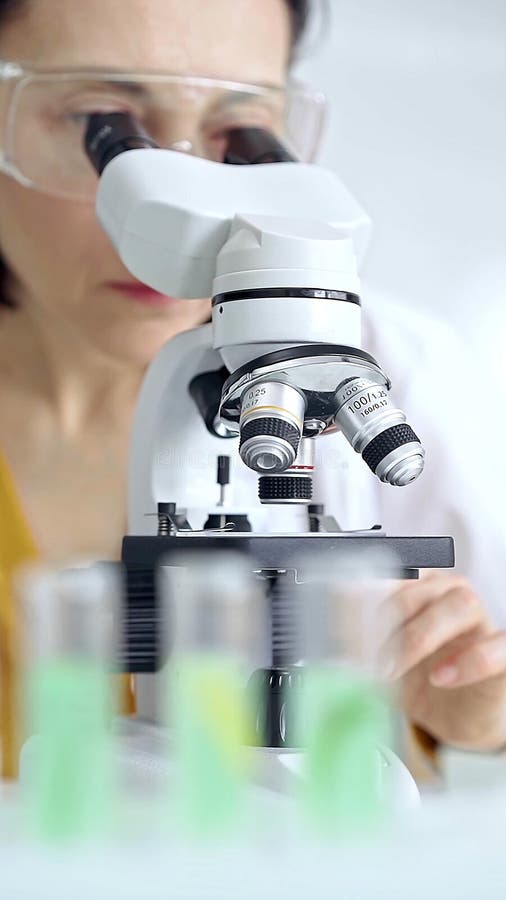 Woman Scientist Using Microscope in Laboratory. Microbiology Science ...