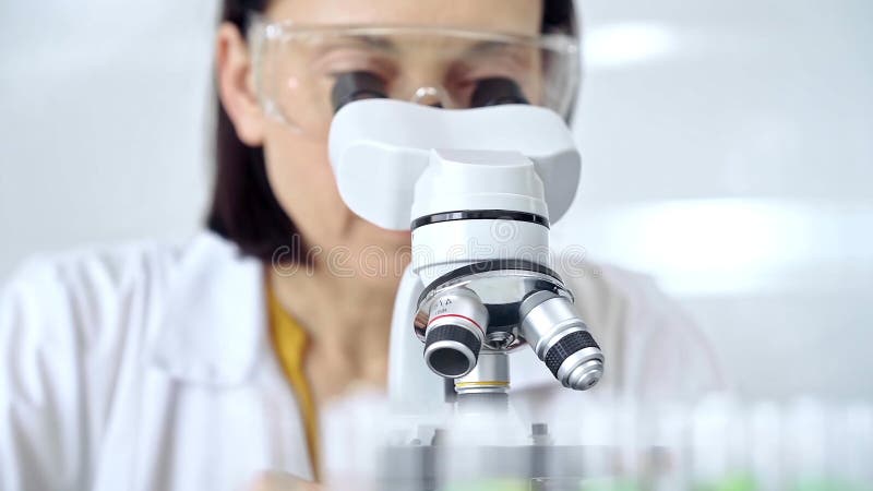 Woman Scientist Using Microscope in Laboratory. Microbiology Science ...