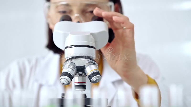 Woman Scientist Using Microscope in Laboratory. Microbiology Science ...