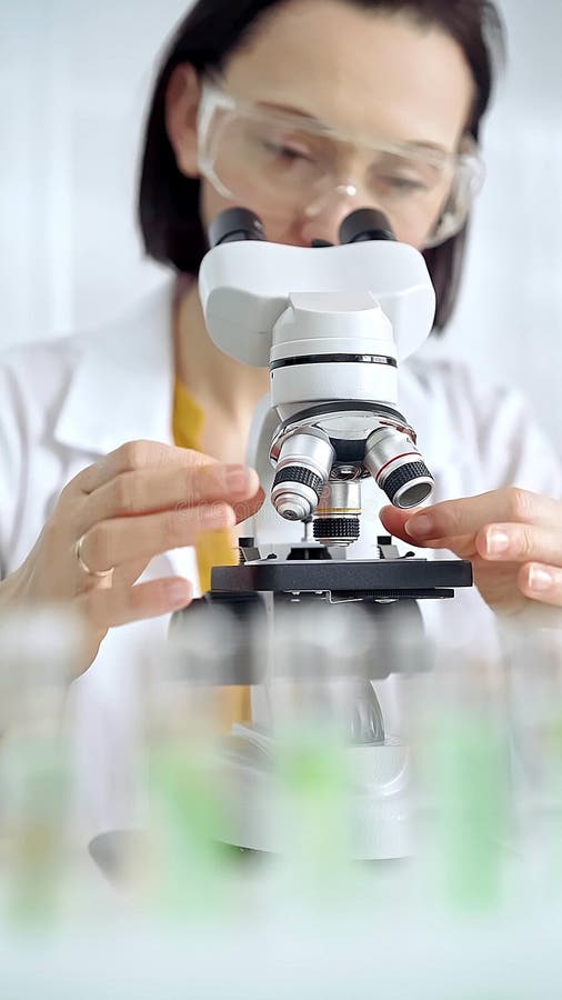 Woman Scientist Using Microscope in Laboratory. Microbiology Science ...