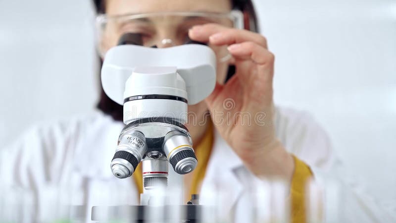 Woman Scientist Using Microscope in Laboratory. Microbiology Science ...