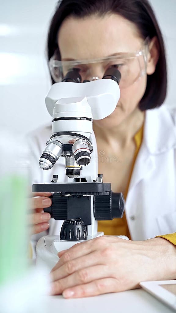 Woman Scientist Using Microscope in Laboratory. Microbiology Science ...
