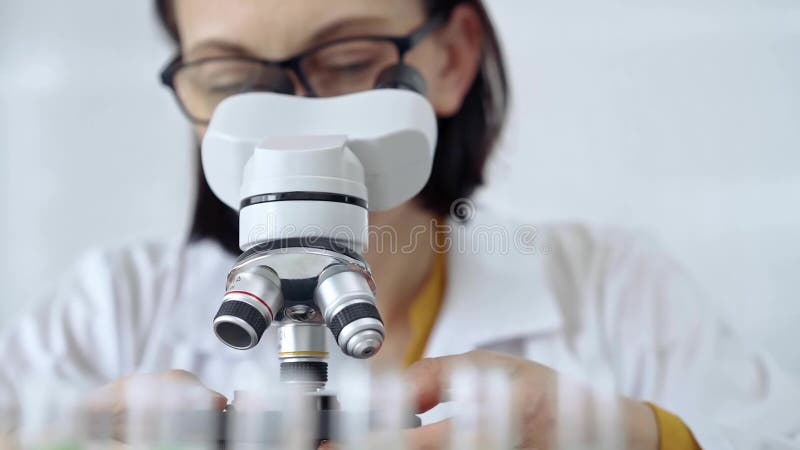 Woman Scientist Using Microscope in Laboratory. Microbiology Science ... Woman Scientist Using Microscope in Laboratory. Microbiology Science ...