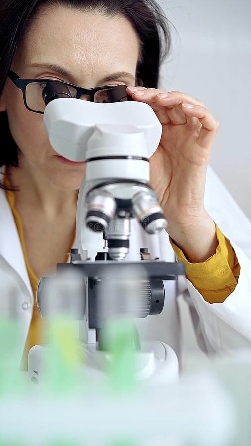 Woman Scientist Using Microscope in Laboratory. Microbiology Science ...