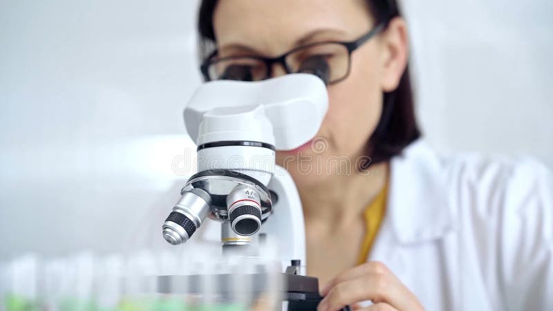 Woman Scientist Using Microscope in Laboratory. Microbiology Science ...