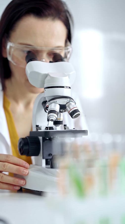 Woman Scientist Using Microscope in Laboratory. Microbiology Science ... Woman Scientist Using Microscope in Laboratory. Microbiology Science ...