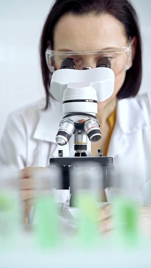 Woman Scientist Using Microscope in Laboratory. Microbiology Science ...