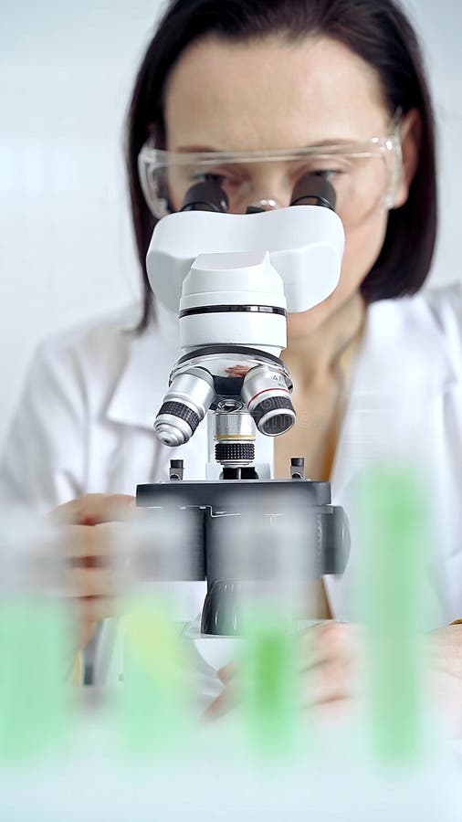Woman Scientist Using Microscope in Laboratory. Microbiology Science ... Woman Scientist Using Microscope in Laboratory. Microbiology Science ...