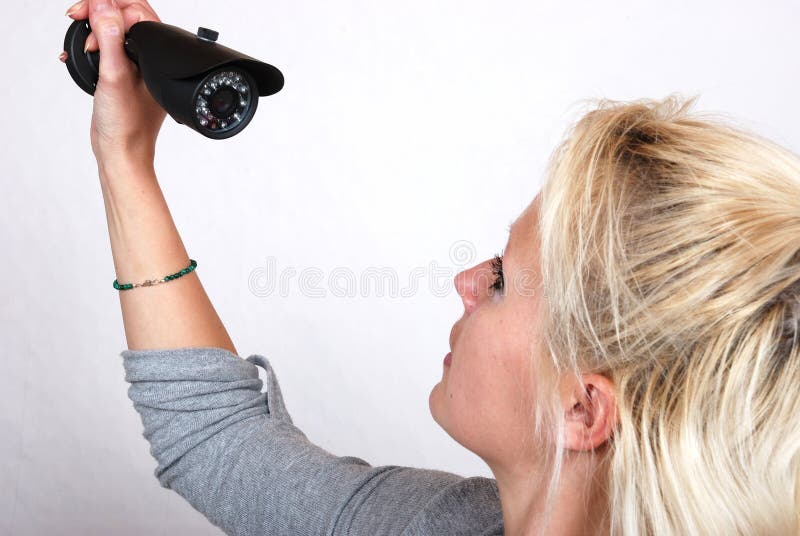 Woman and security camera stock photo. Image of face - 59214442