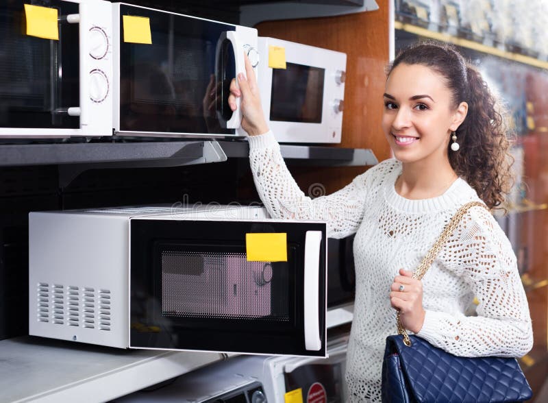 Woman Selecting Microwave Oven Stock Image - Image of girl, oven: 73516417