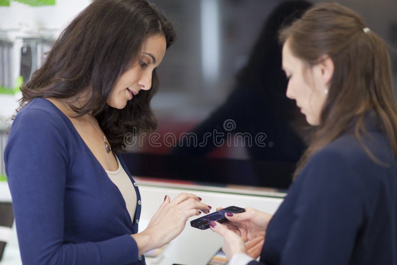 Woman selling a cell phone stock photo. Image of sell - 24609044