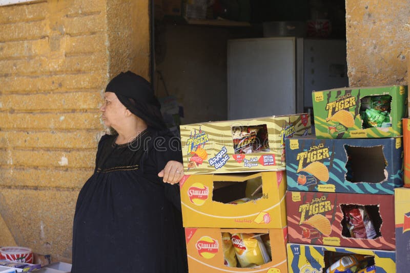 Woman selling crisps editorial photo. Image of veil, black - 29590246
