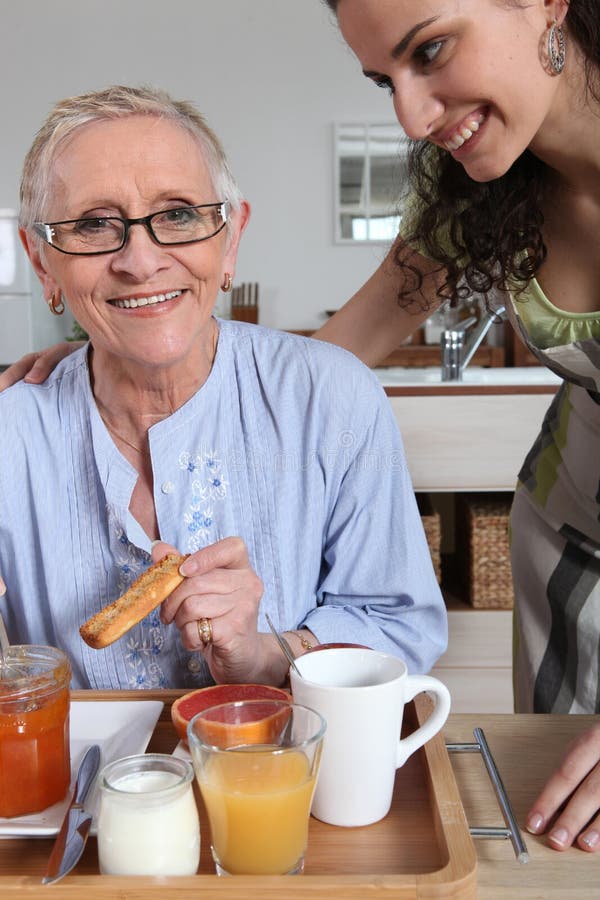 Woman serving breakfast stock image. Image of assist - 27812089